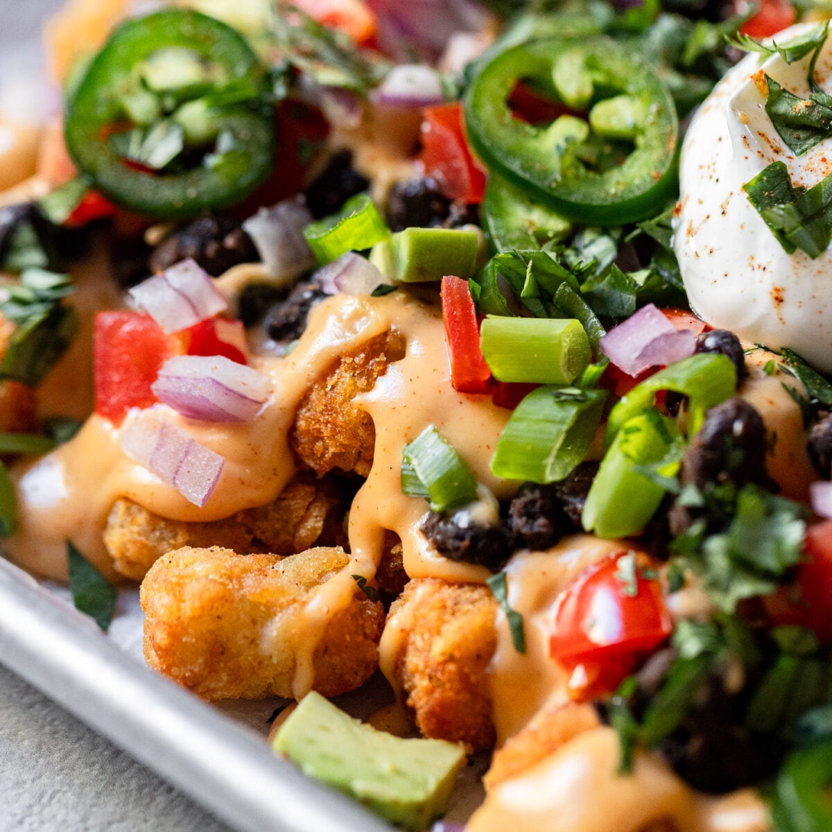Loaded Totchos with Black Beans and Nacho Cheese Sauce